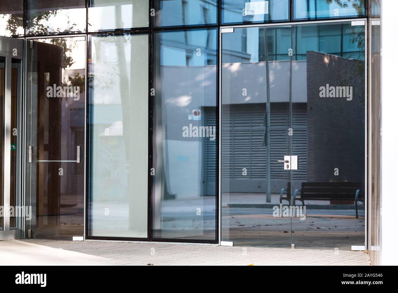 Modern glass entrance of an office building Stock Photo - Alamy