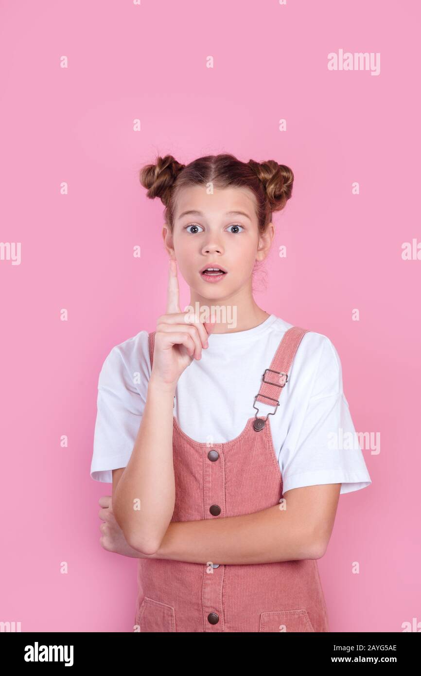 Joyful little girl raising hand hi-res stock photography and images - Alamy