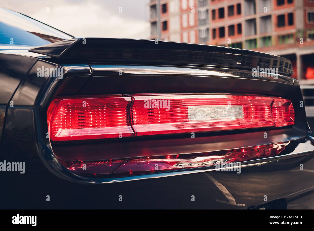 Detail of red metallized black rear car headlight in eye shape, with ...