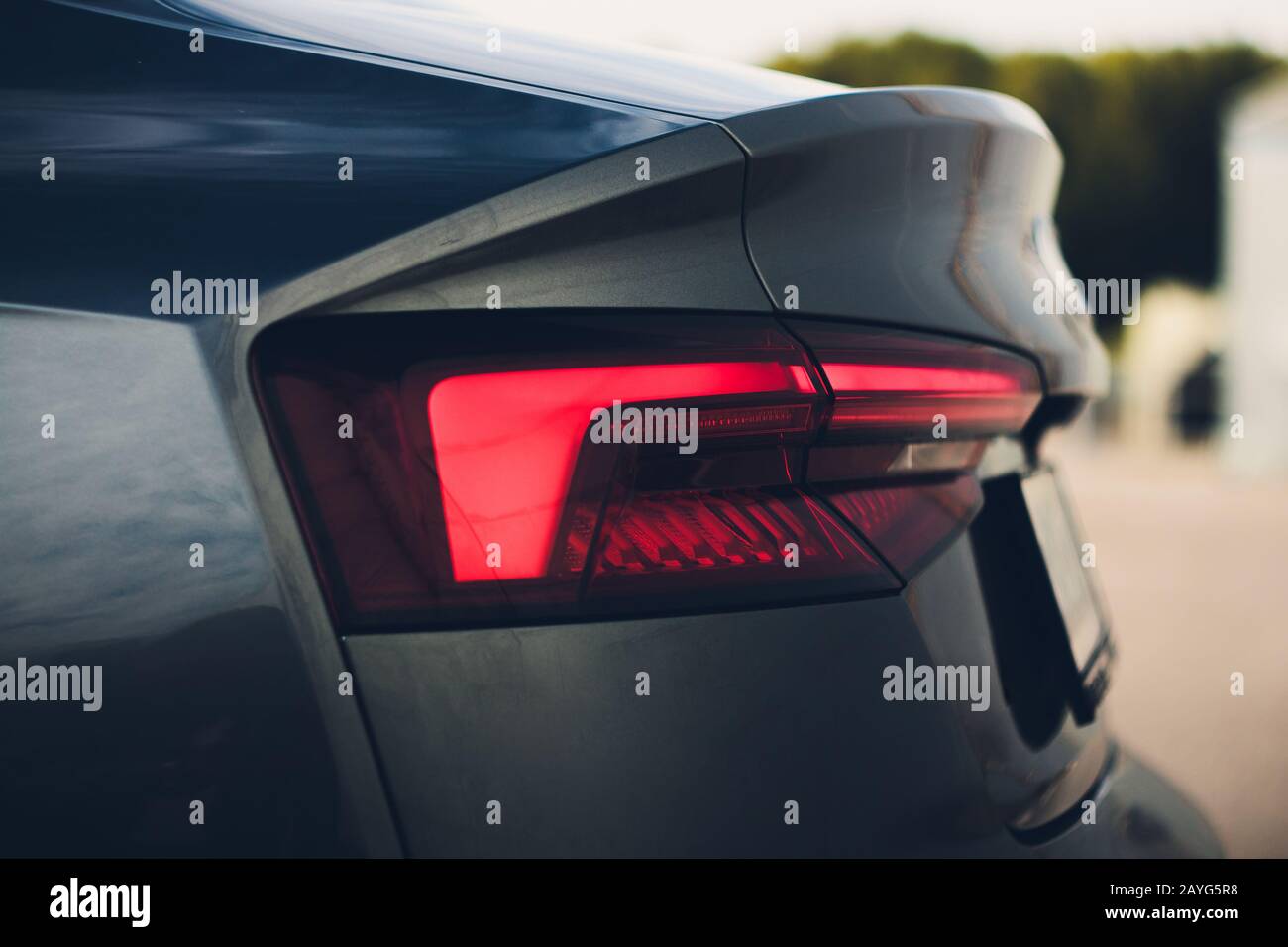 Detail of red metallized black rear car headlight in eye shape, with ...