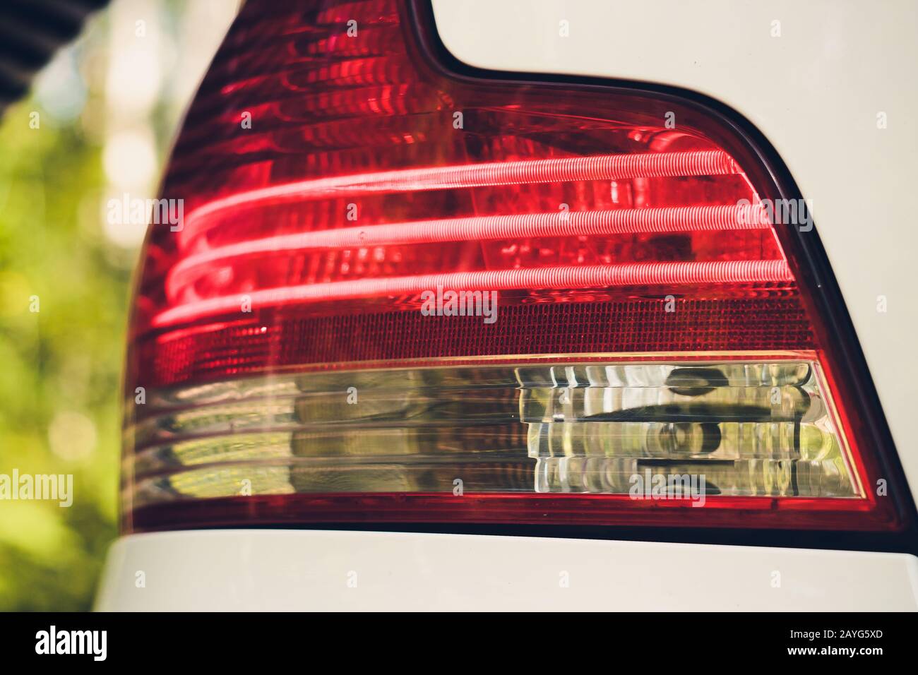 Detail of red metallized black rear car headlight in eye shape, with ...