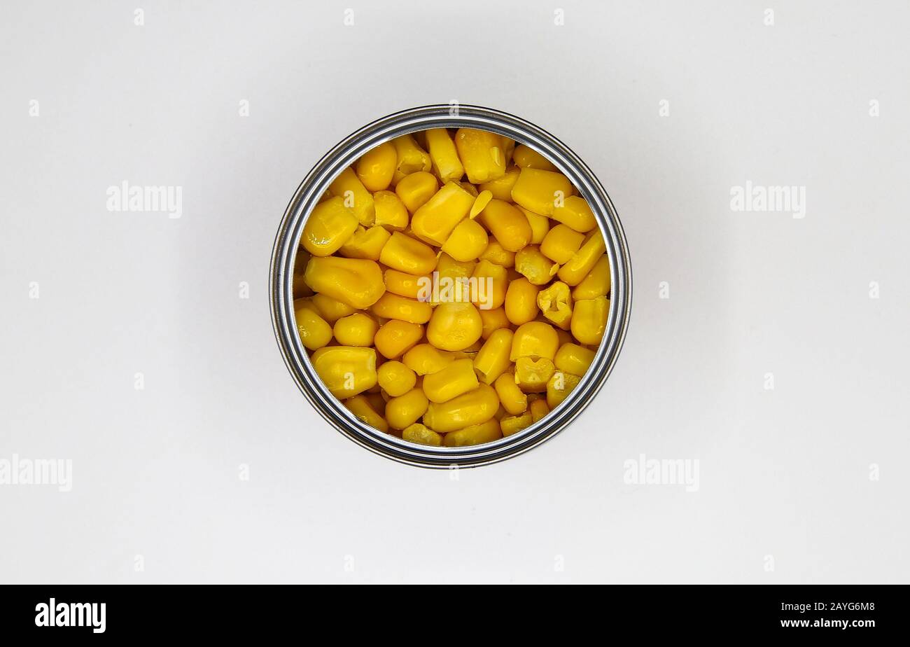 Top view close up on isolated open metal can with yellow sweet corn ...