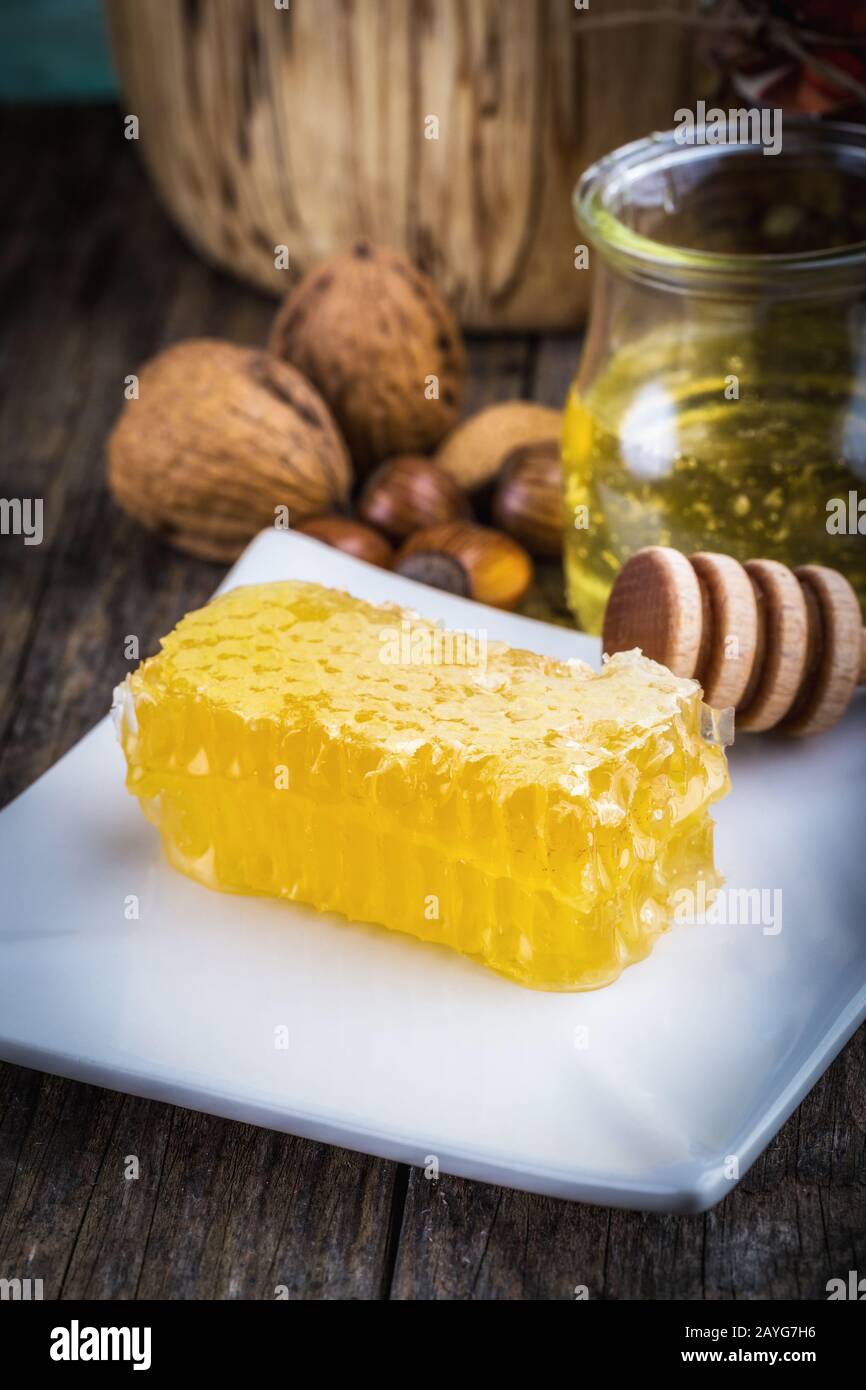 honey dipper and honeycomb, nuts in honey and nuts of various kinds ...