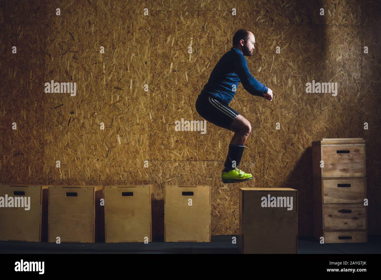 Photo of a sportsman working out his body in box jumping Stock Photo ...