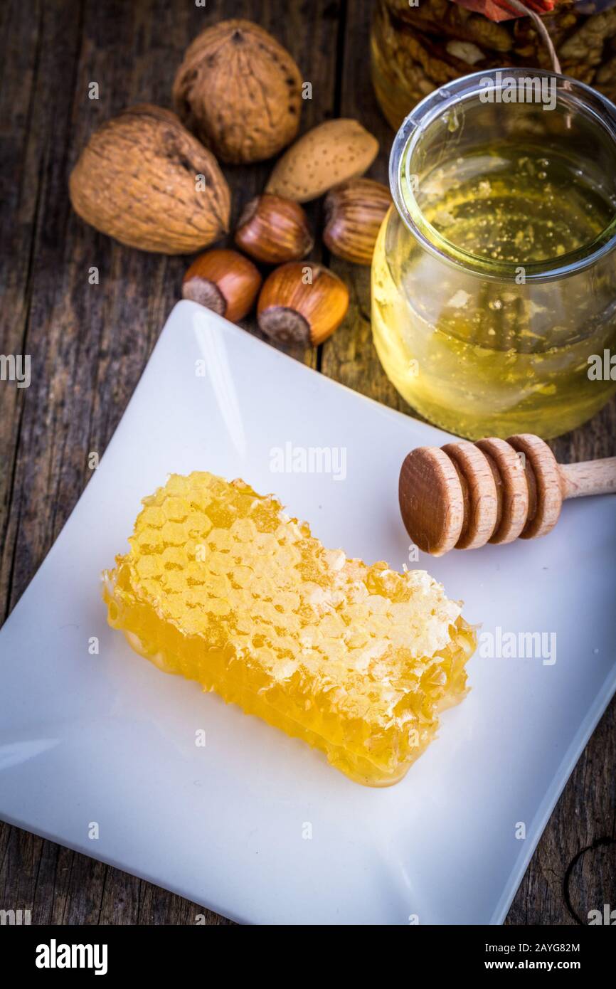 honey dipper and honeycomb, nuts in honey and nuts of various kinds ...