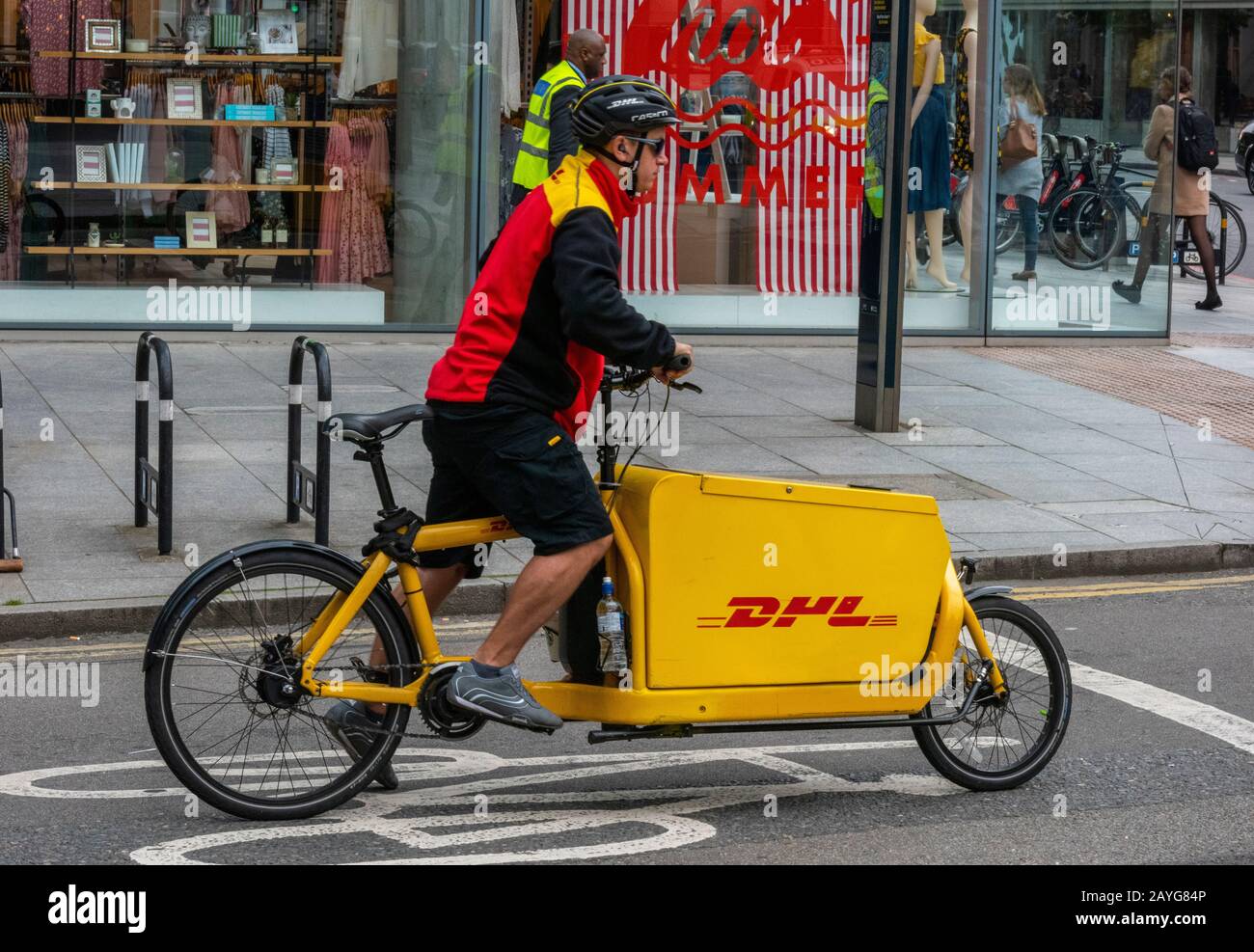 a dhl cycle courier in the centre of the city of London riding a ...
