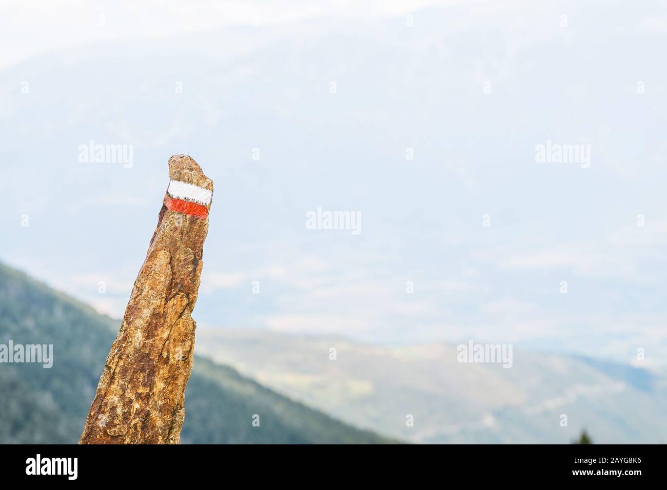 Stone with the mark of trekking path Stock Photo - Alamy