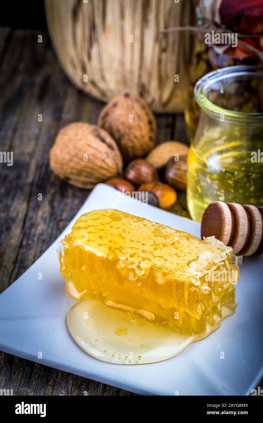honey dipper and honeycomb, nuts in honey and nuts of various kinds ...
