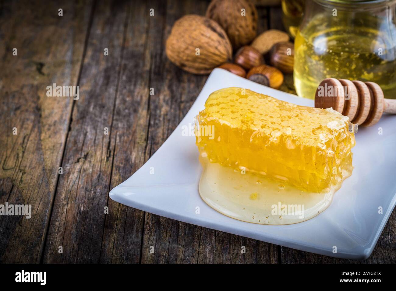 honey dipper and honeycomb, nuts in honey and nuts of various kinds ...