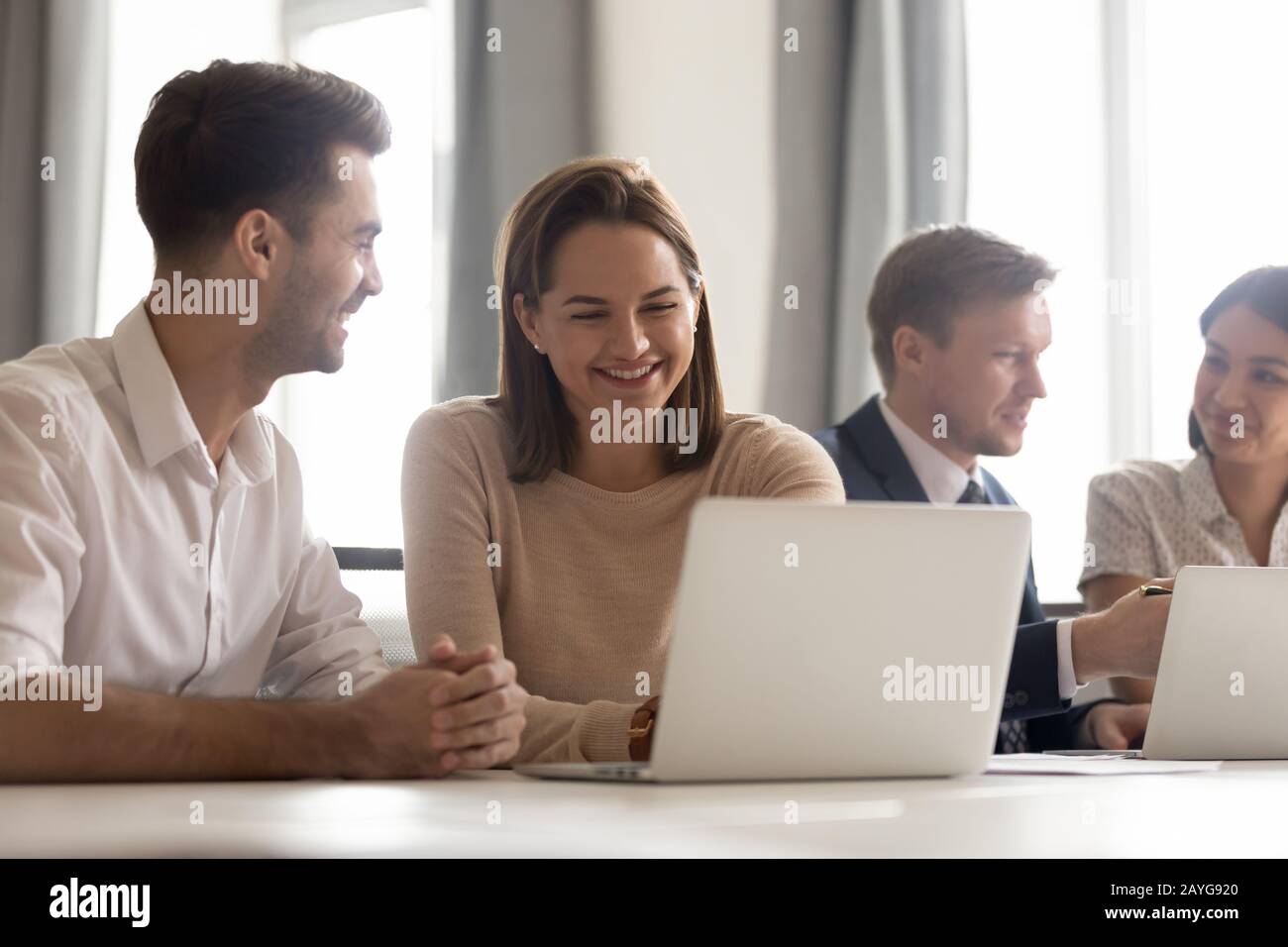 Diverse employees work in groups discussing ideas in office Stock Photo ...