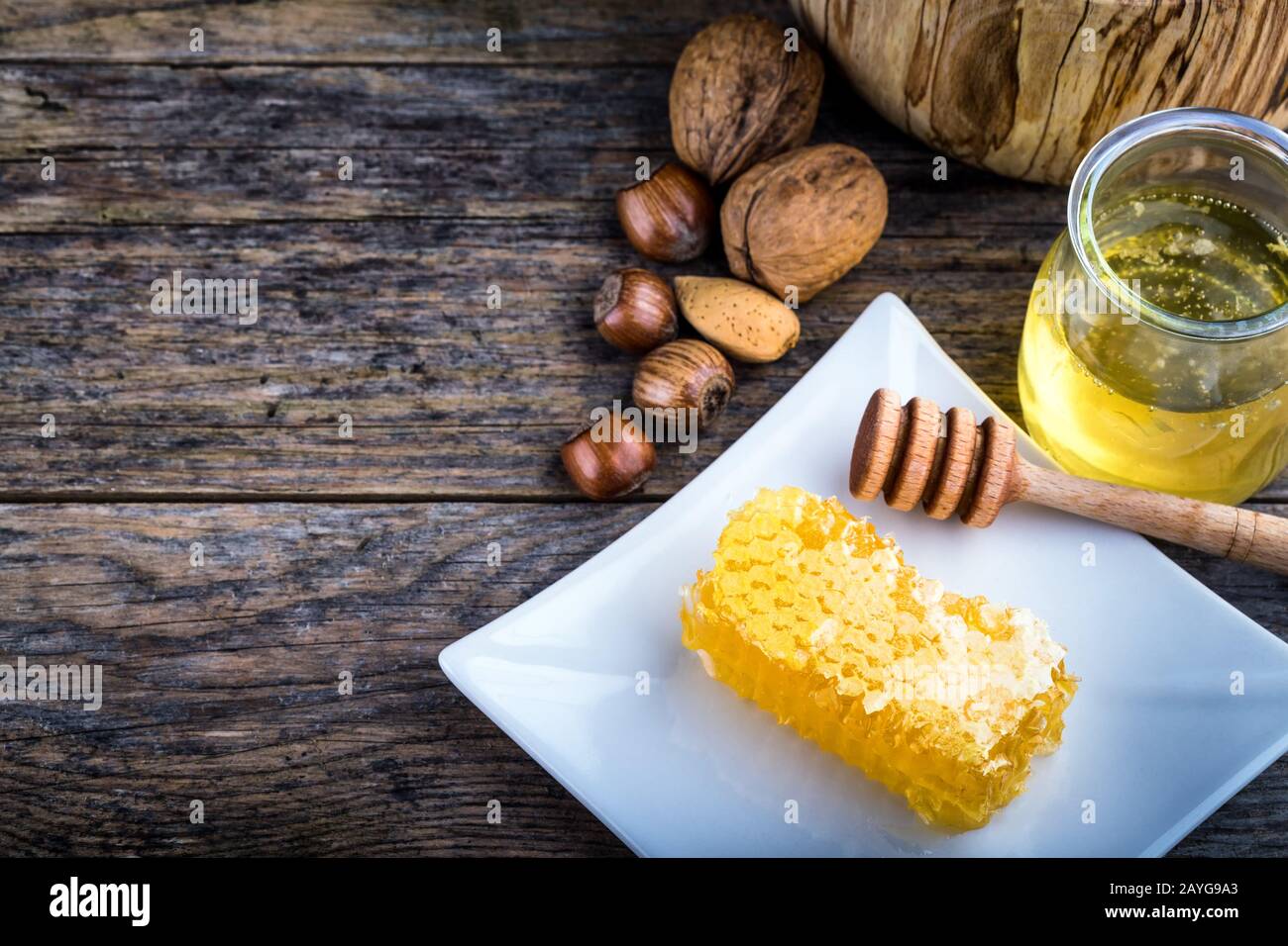 honey dipper and honeycomb, nuts in honey and nuts of various kinds ...