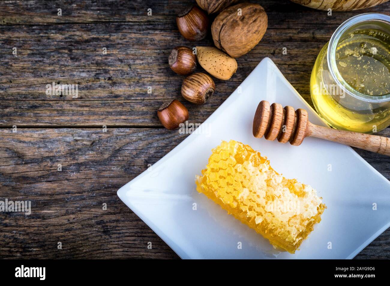 honey dipper and honeycomb, nuts in honey and nuts of various kinds ...