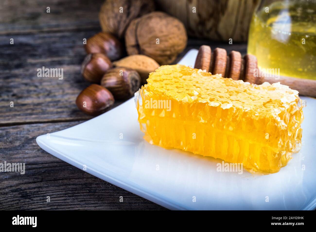 honey dipper and honeycomb, nuts in honey and nuts of various kinds ...