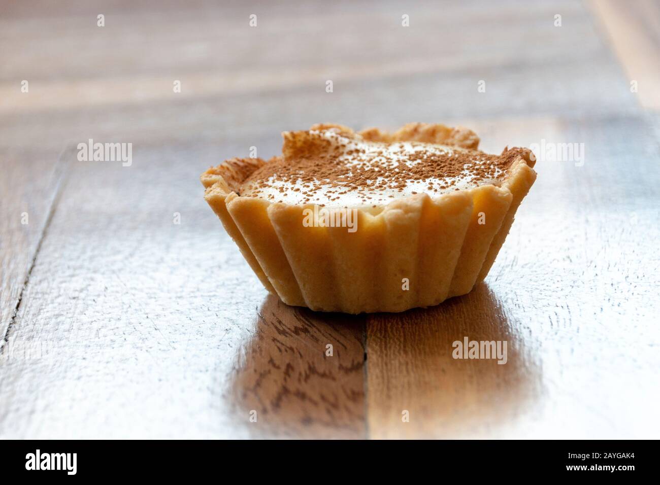 A close up view of a small homemade milk tart on a isolated background ...