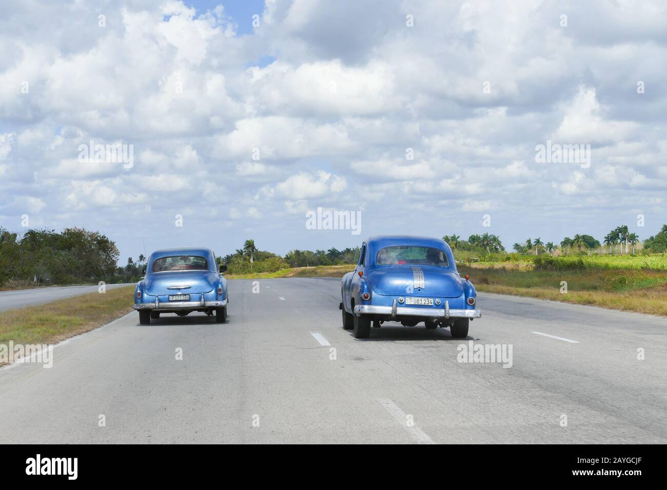 Cuba two old blue cars on the road. Photo taken from a car Stock Photo ...