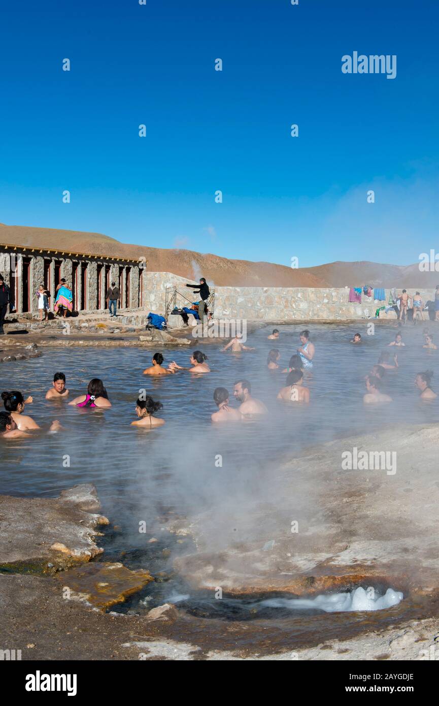 Tourists bathing in hot springs at El Tatio Geysers geothermic basin ...