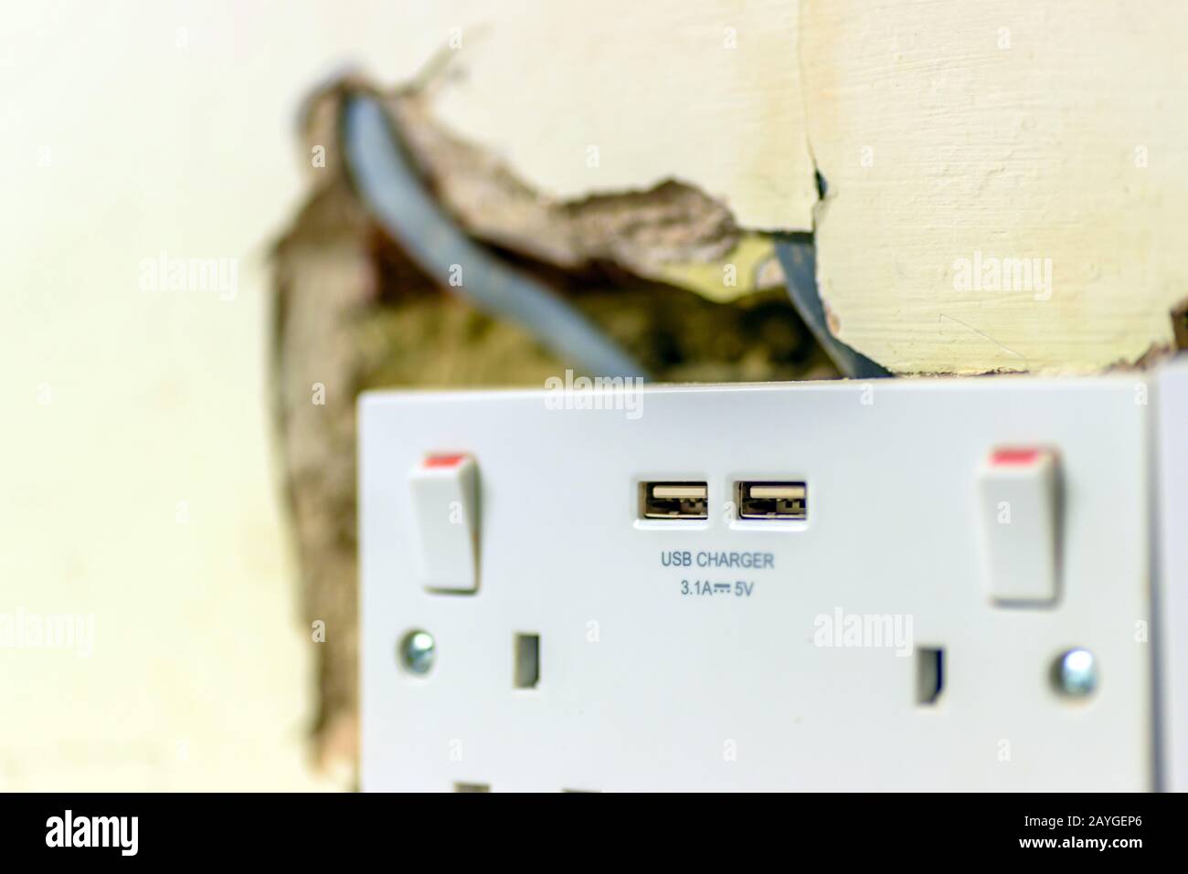 electric socket in a wall during renovation in england uk Stock Photo ...