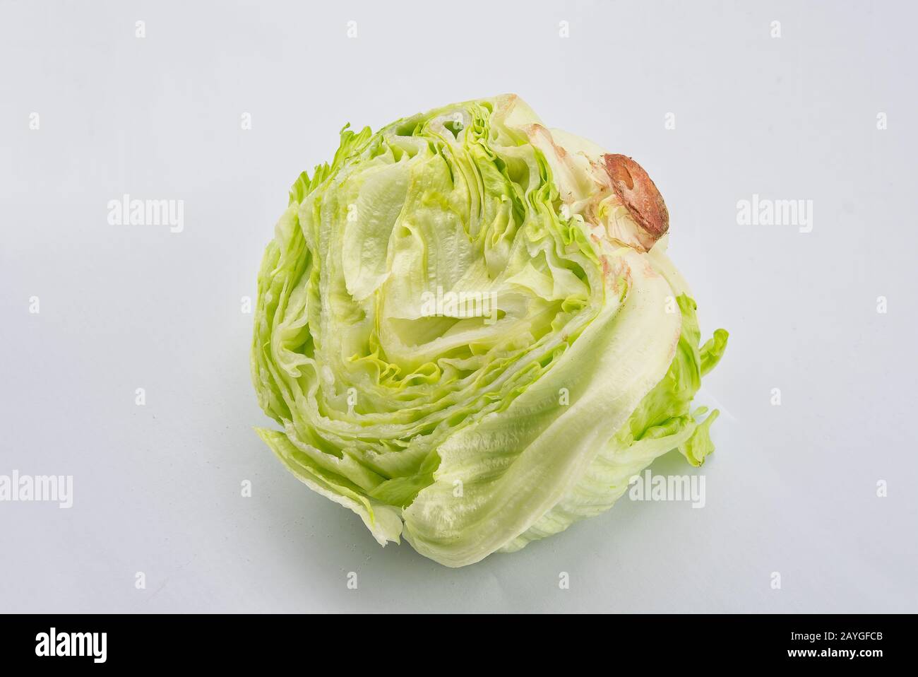 View of a half cut open Iceberg letttce on a white background Stock ...