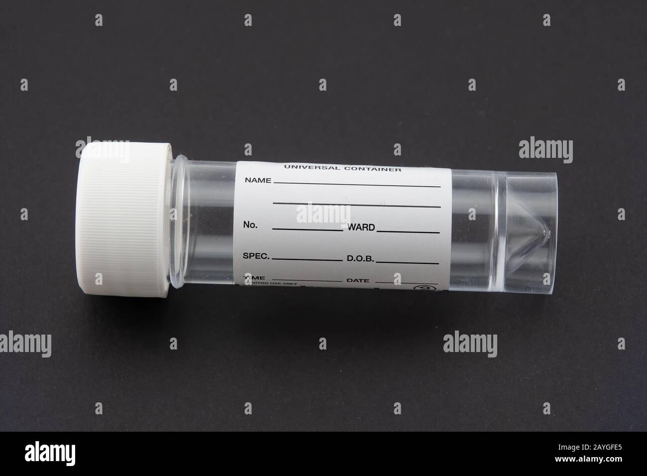 clear plastic specimen container with a white lid on a black background ...