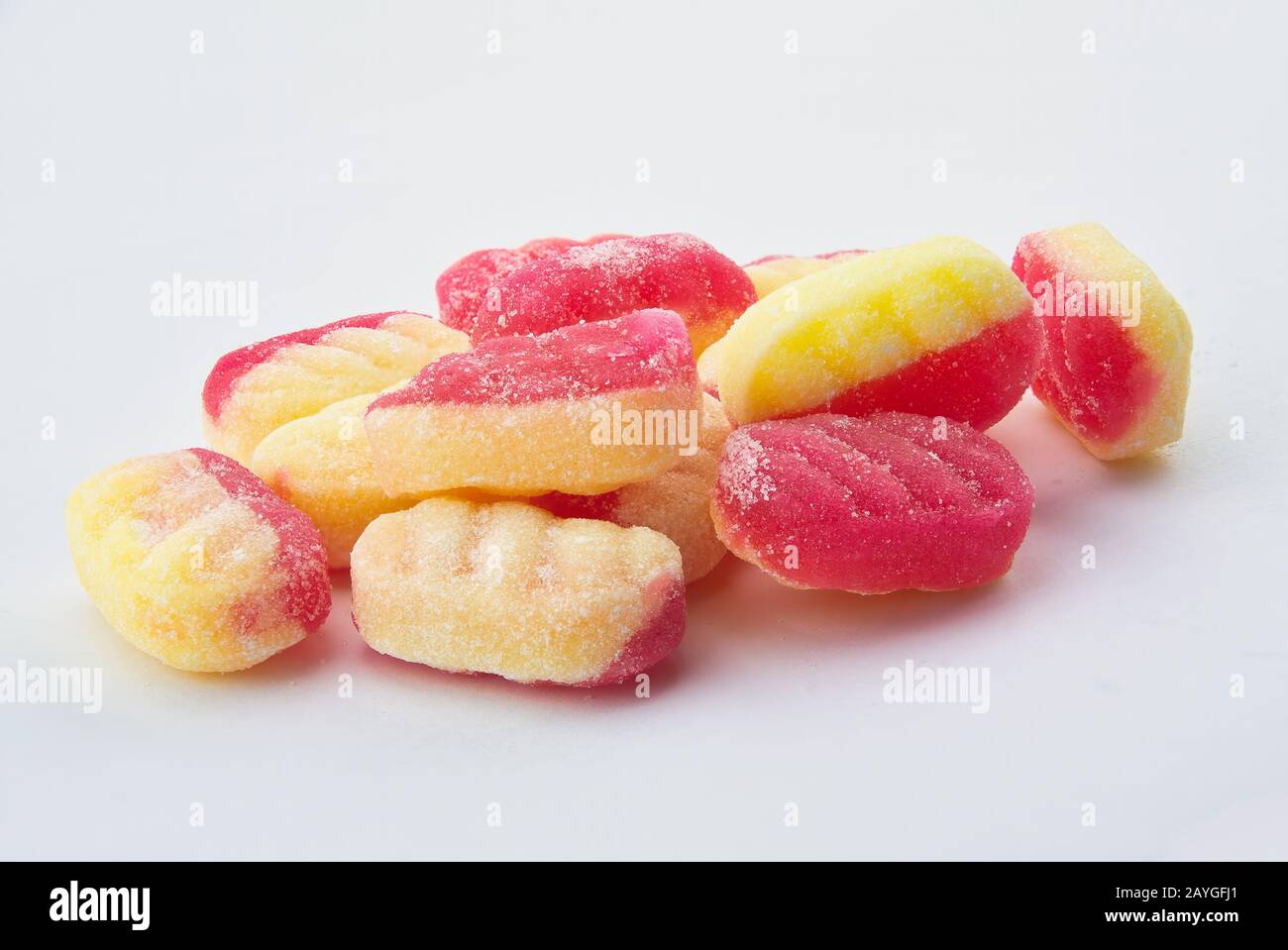 A pile of Rhubarb and Custard candy on a white background Stock Photo ...