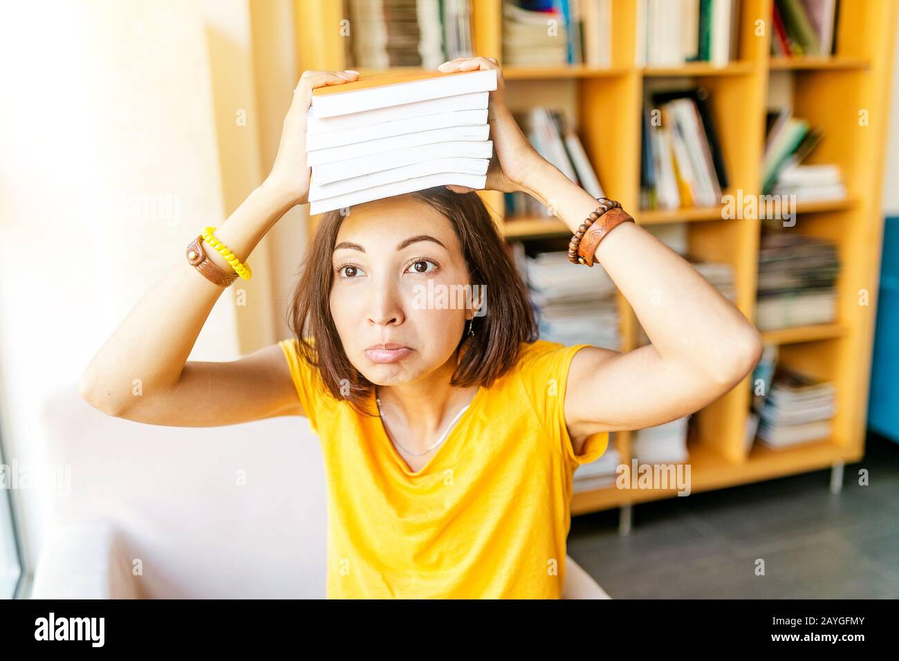 Sad and tired girl student doing homework in class Stock Photo - Alamy