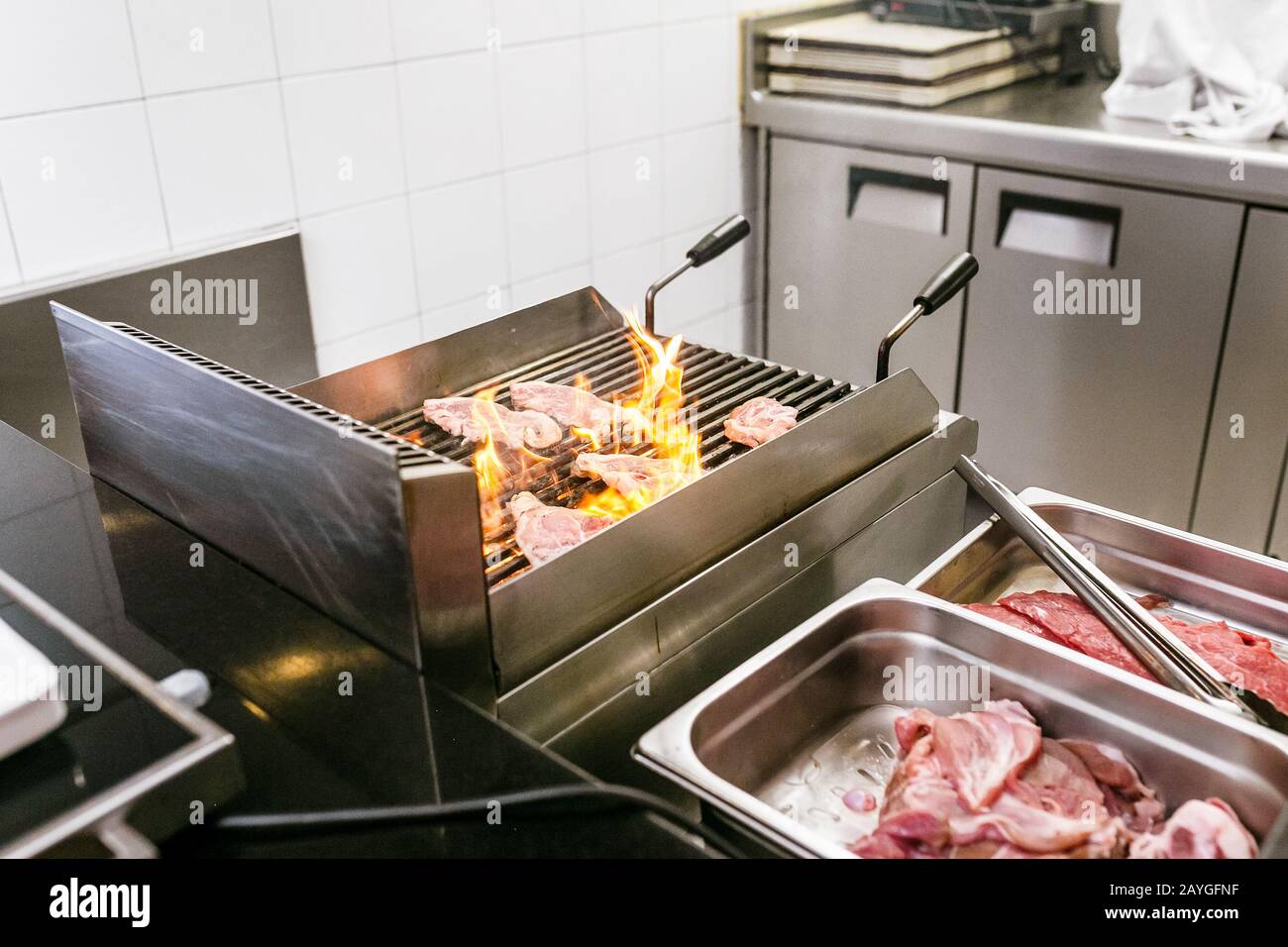 grilling steaks with fire at the kitchen Stock Photo - Alamy