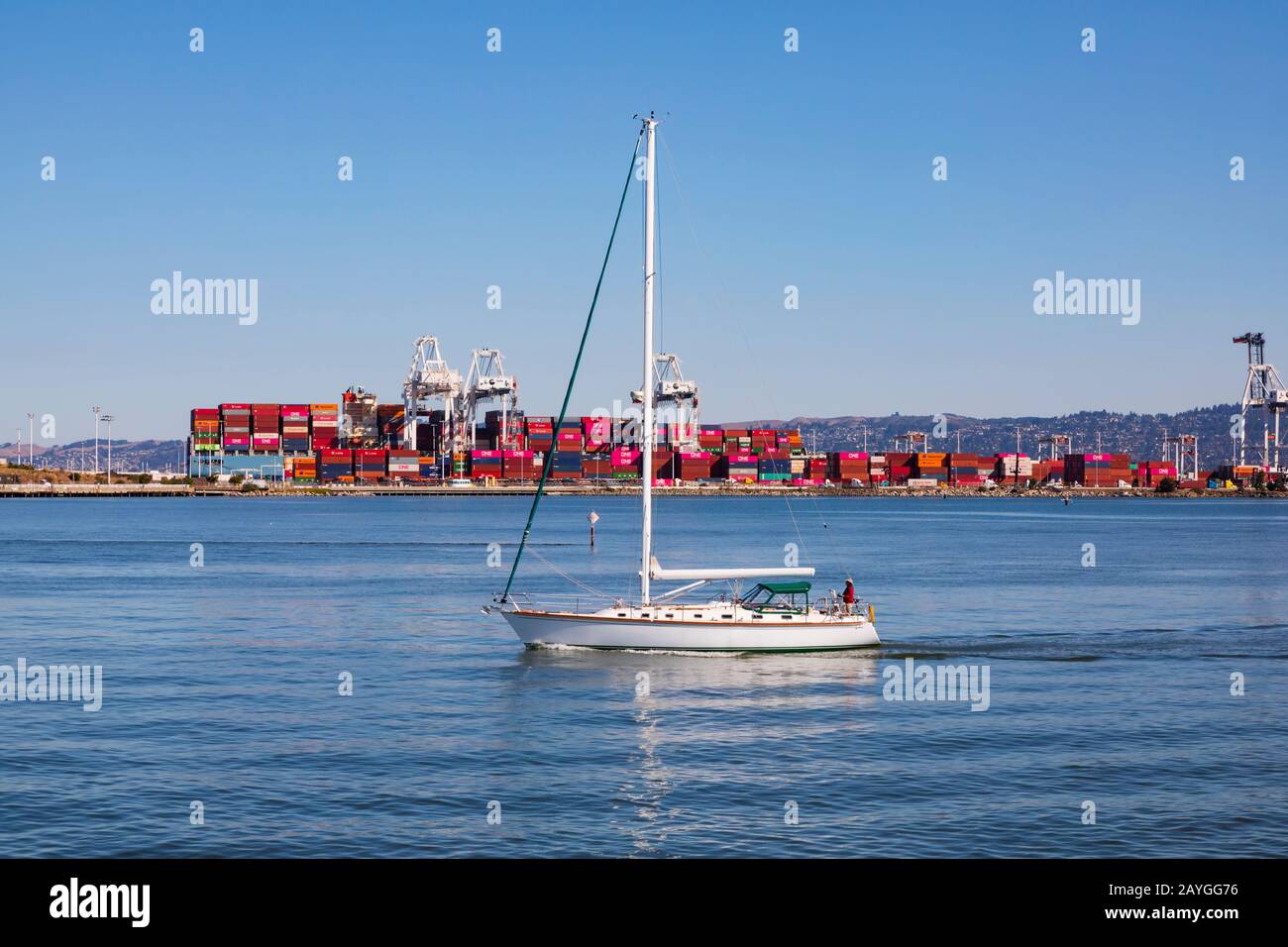 A yacht passes the Port of Oakland container terminal, heading into San ...
