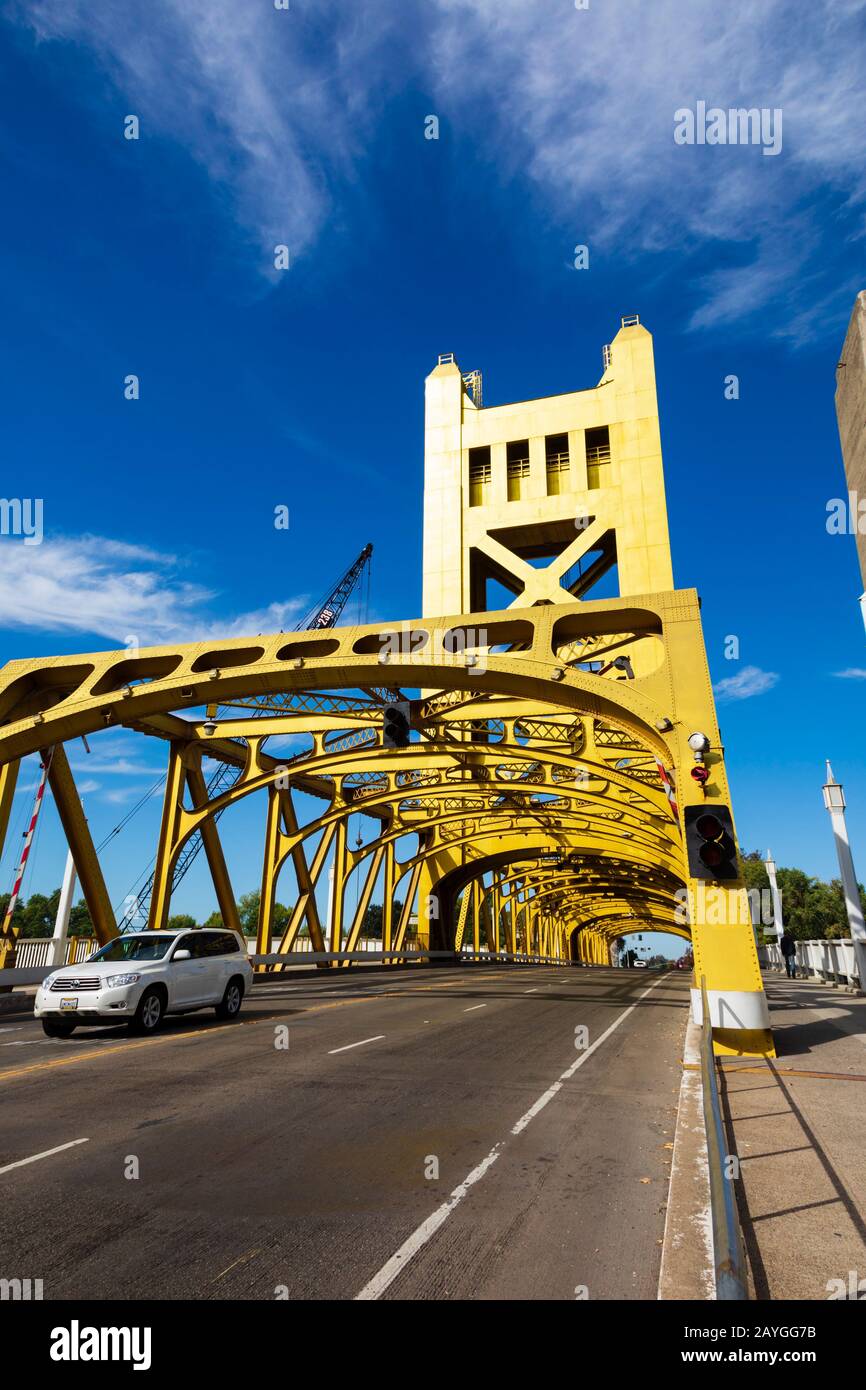 Car crossing The gold painted Tower Bridge over the Sacramento River ...