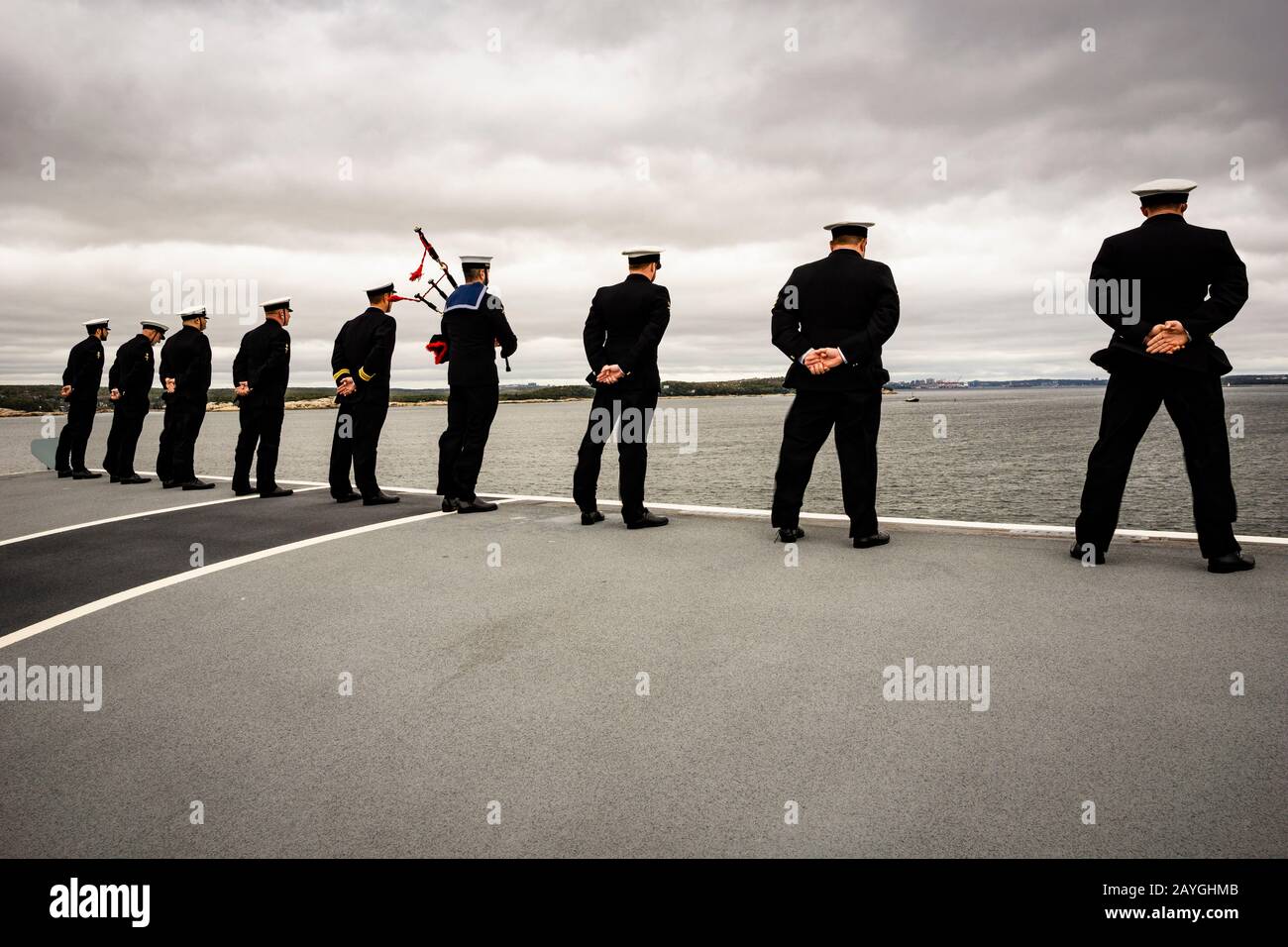 Sailors man the rails on the launch ramp of the Royal Navy's aircraft ...