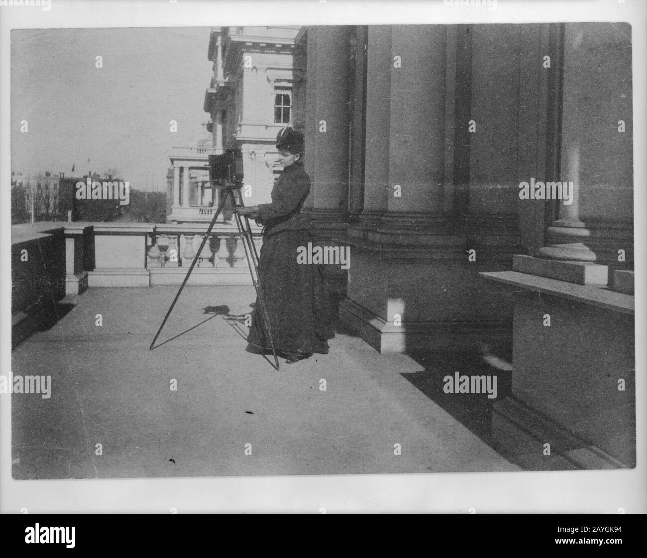 Frances Benjamin Johnston with camera on balcony of State, War and Navy ...