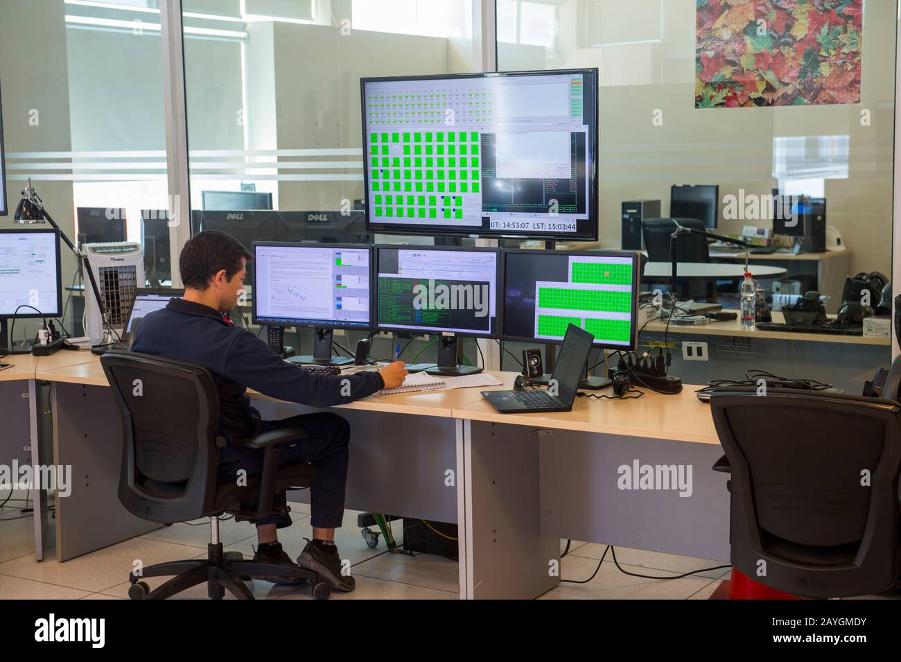 Scientist working in a control room at ALMA (Atacama Large Millimeter ...