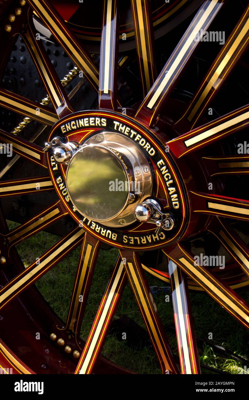 close up of the polished wheel of a traction engine at the steam fair ...