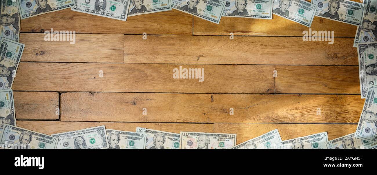 Banner sized background of used dollars banknotes lying on wooden floor ...