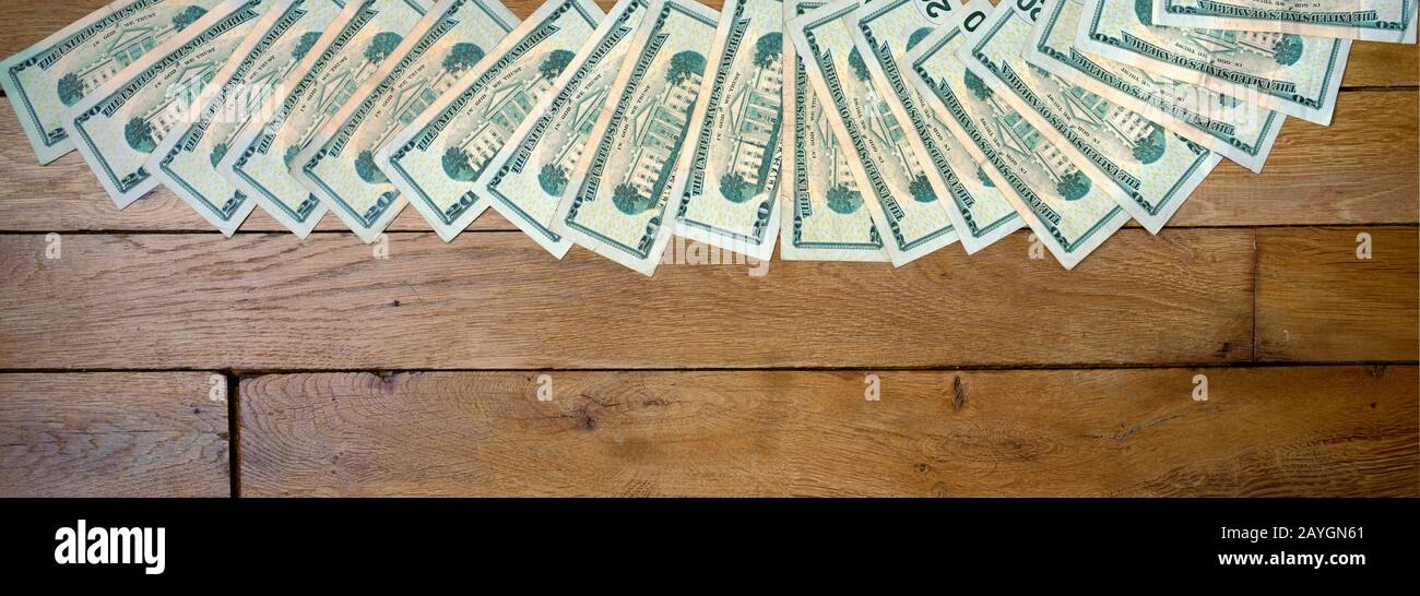 Banner sized background of used dollars banknotes lying on wooden floor ...