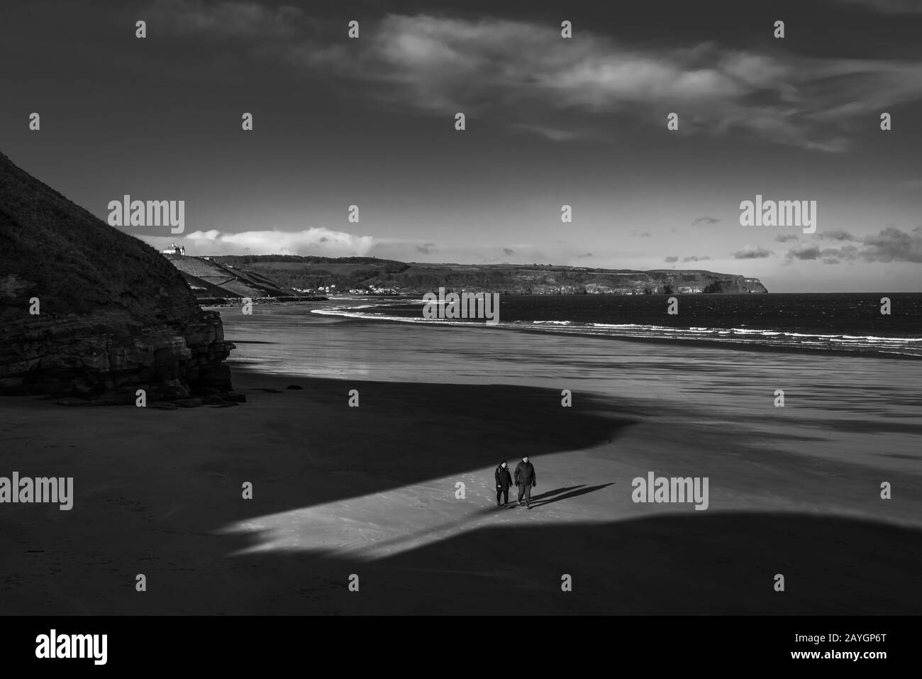 Whitby beach. A cliff is in the foreground and and a headland is in the ...