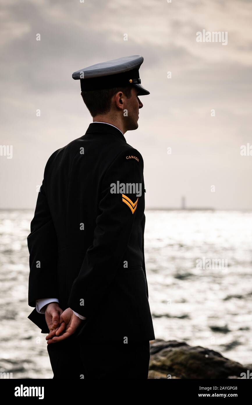 A sailor stands at ease during a ceremony to mark the 50th anniversary ...
