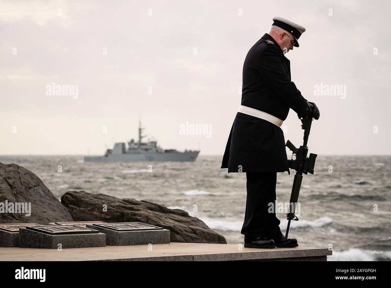 A sailor stands at attention during a ceremony to mark the 50th ...