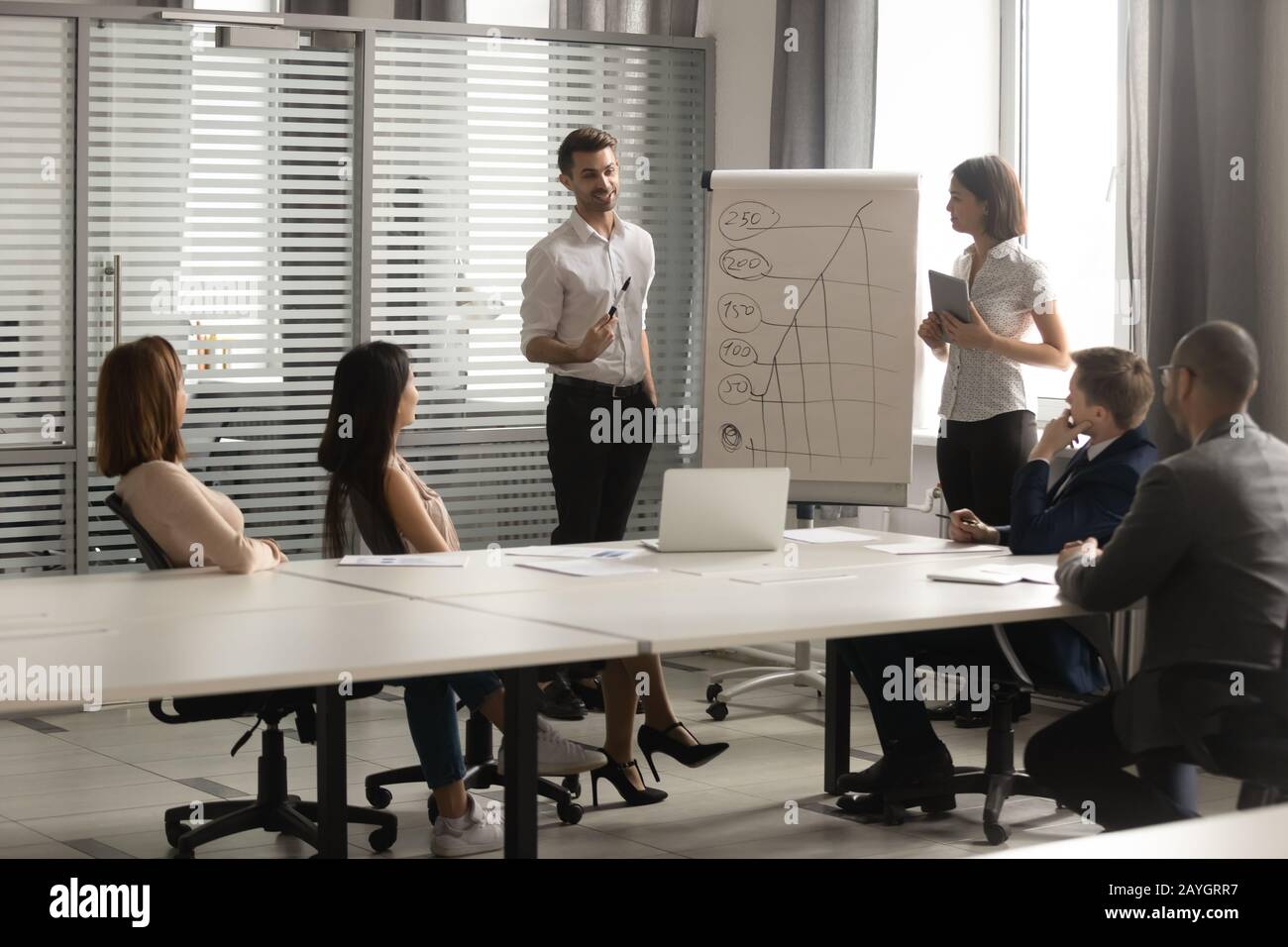 Male coach make whiteboard presentation at office briefing Stock Photo ...