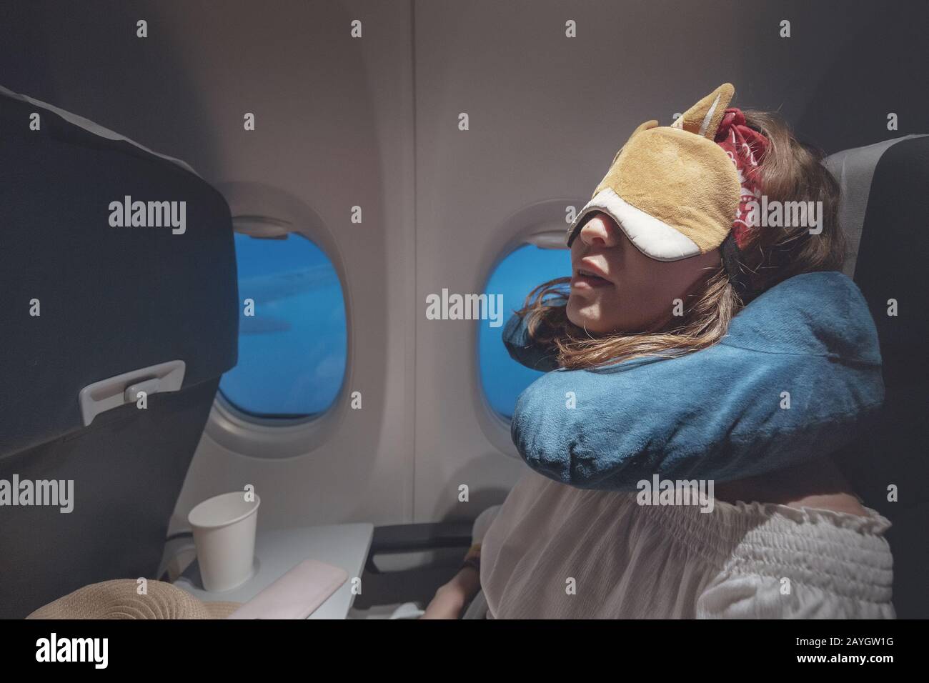 Woman sleeping plane hi-res stock photography and images - Alamy