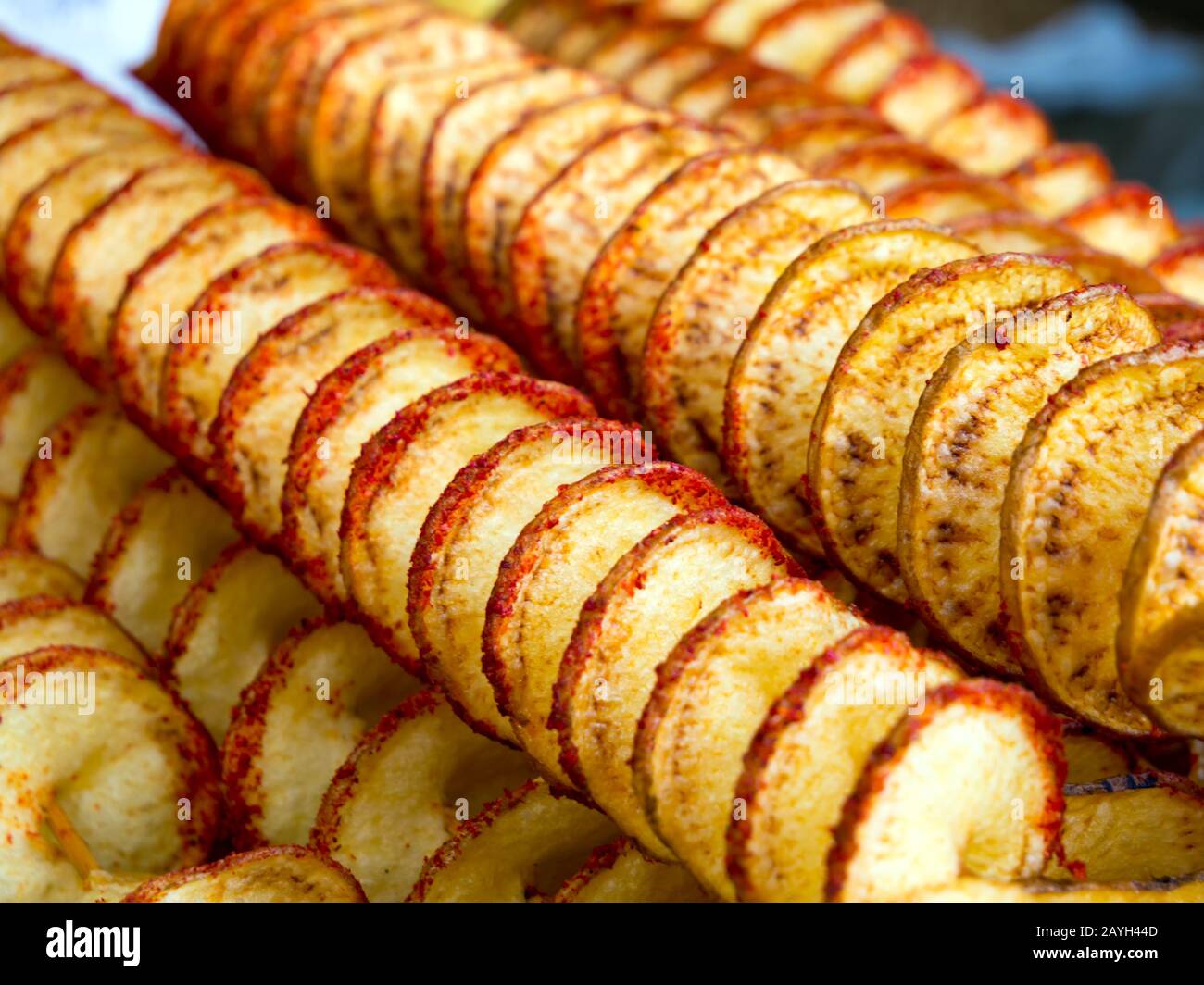 Spiral-shaped potato chips with added different spices Stock Photo - Alamy