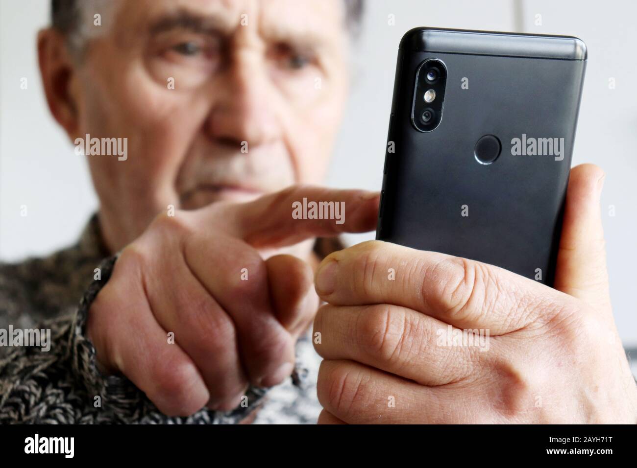 Elderly man using smartphone, mobile phone in male hands close up ...