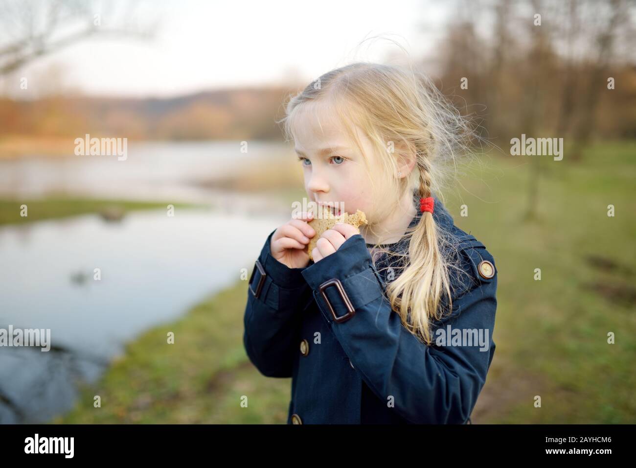 Cute young girl having fun on beautiful spring day. Active family ...