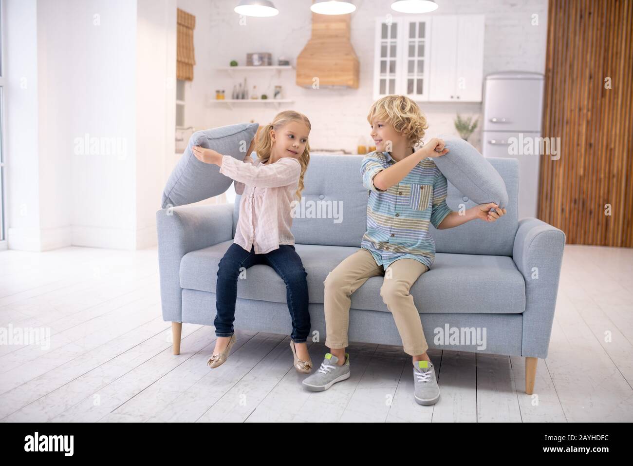 Two kids beating each other with pillows and feeling enjoyed Stock ...