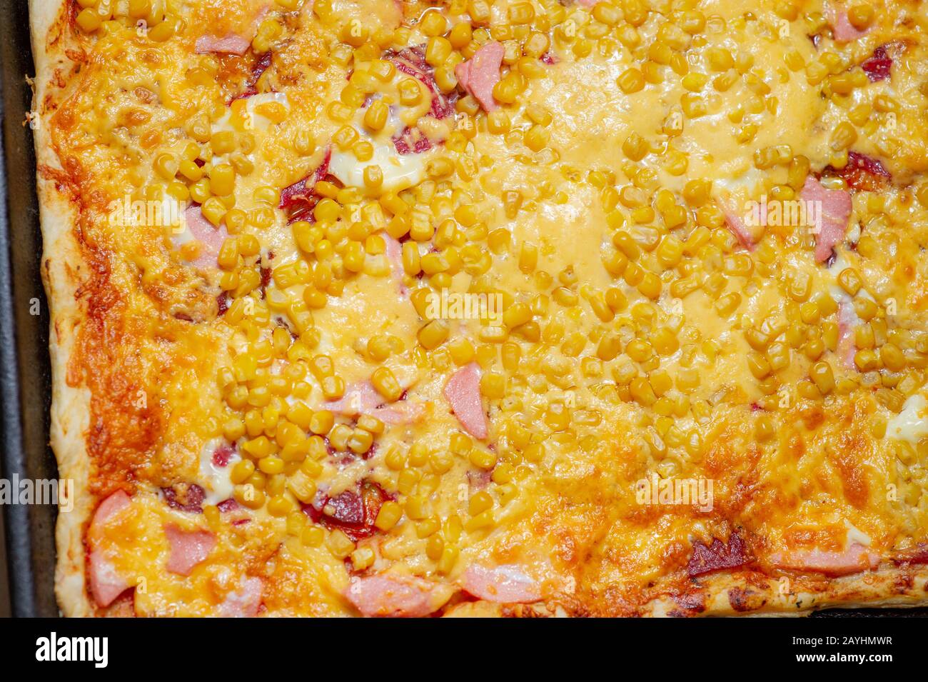 Homemade pizza with cheddar cheese and corn Stock Photo - Alamy