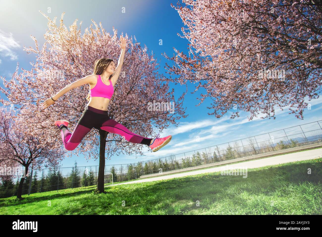Woman outside run and jump hi-res stock photography and images - Alamy