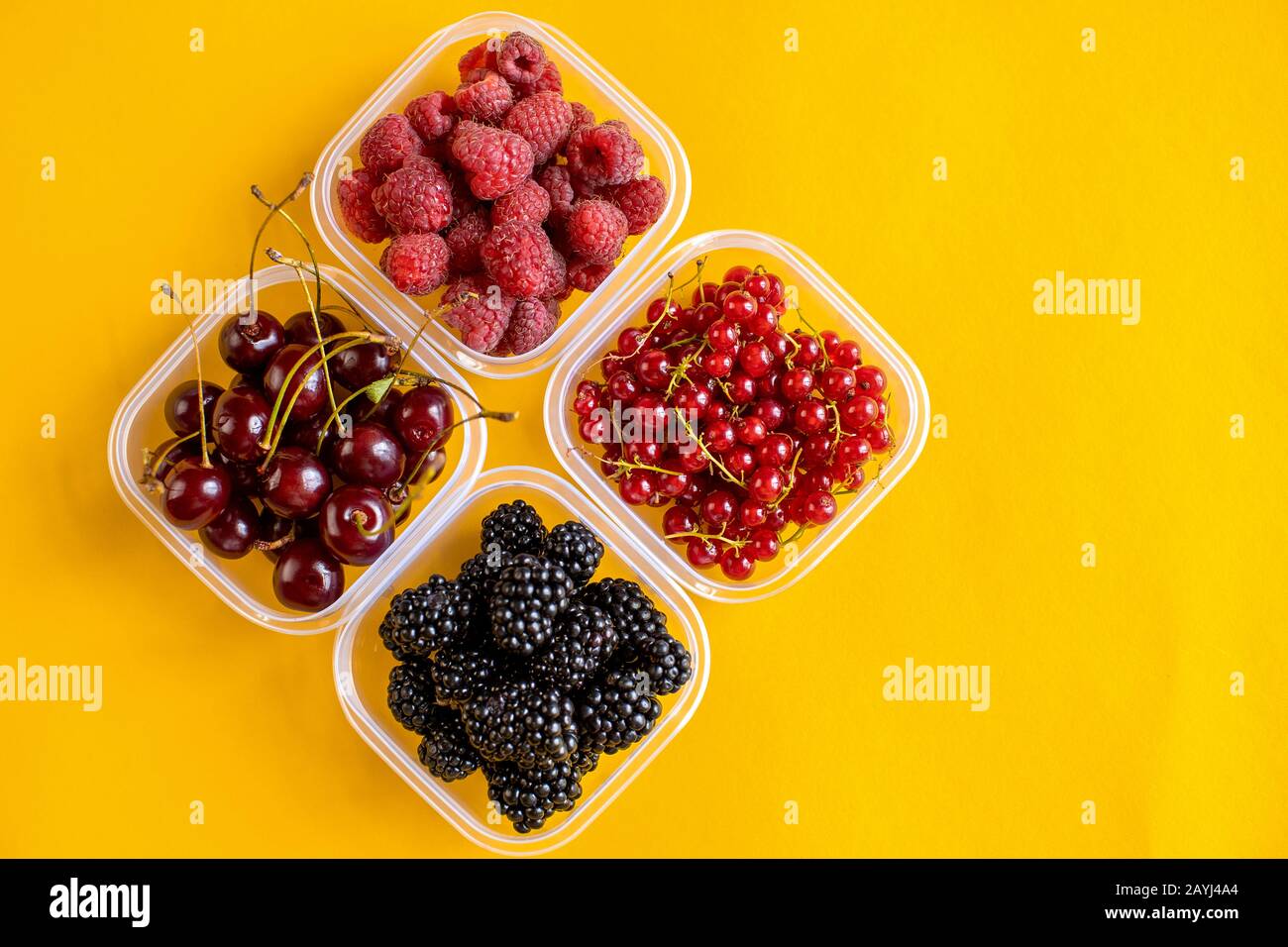 4 plastic plates, containers with raspberry, blackberry, red currant ...