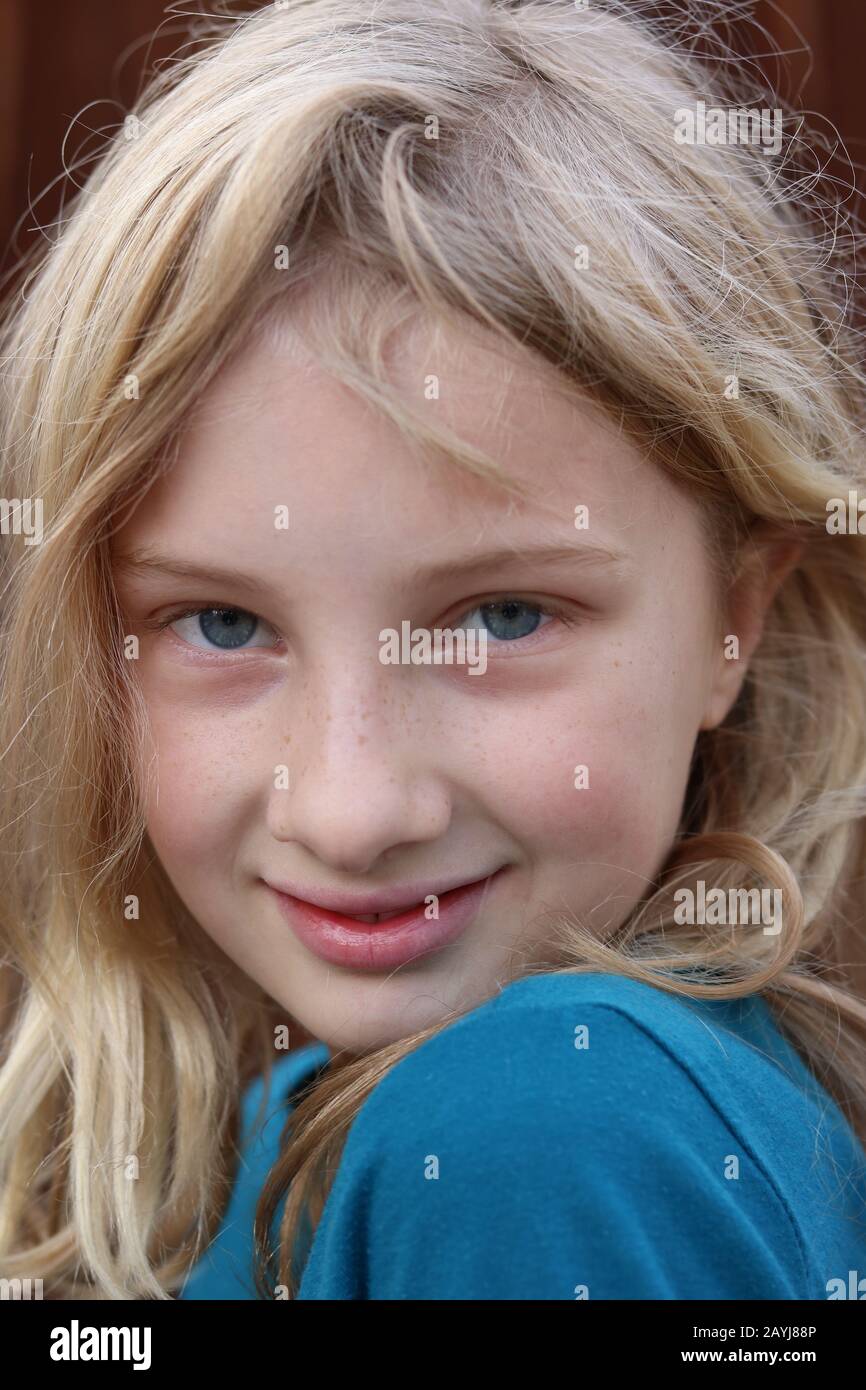 Portrait of a young teenager with a coy stare Stock Photo - Alamy