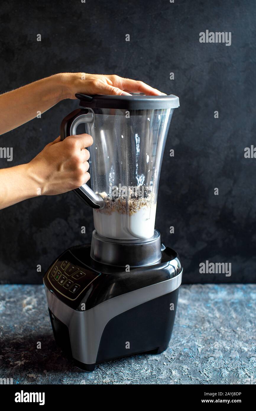Making a healthy smoothie on a blender Stock Photo - Alamy