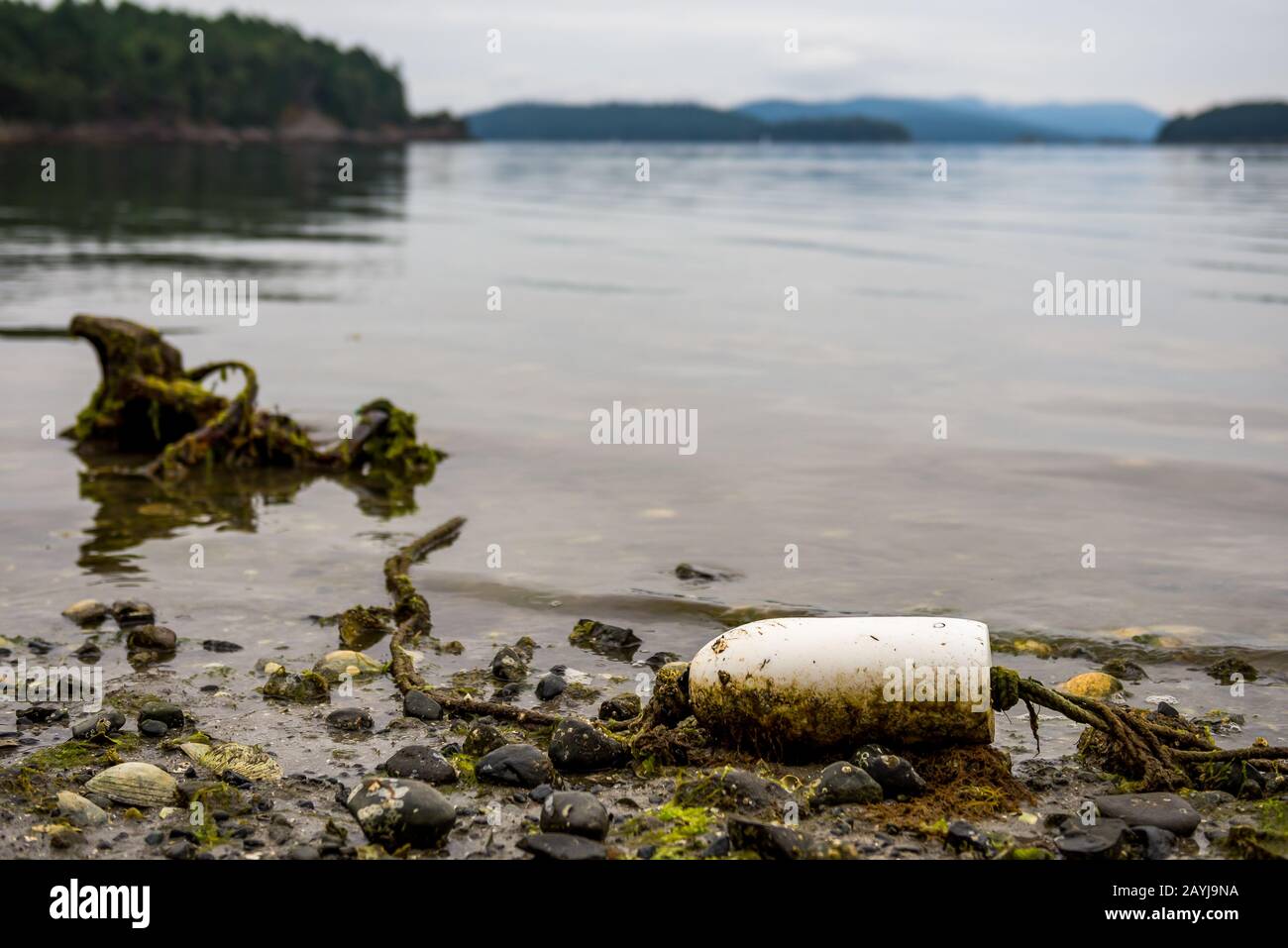 Left over marine garbage on beach small fishing buoy and rope Stock ...