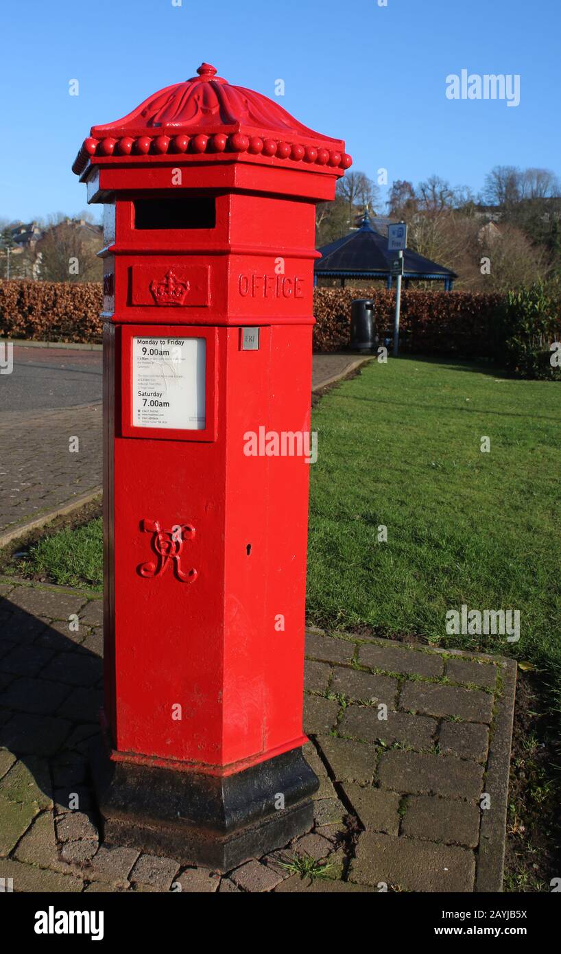 Red hexagonal Victorian Royal Mail pillar box on Abbey Bridge End (road ...